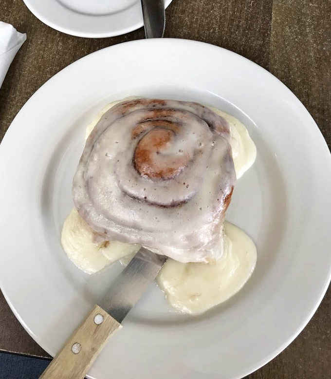 This isn't just a cinnamon roll &ndash; it's a spiral-bound love letter to your taste buds, served with a side of banana slices for plausible deniability.