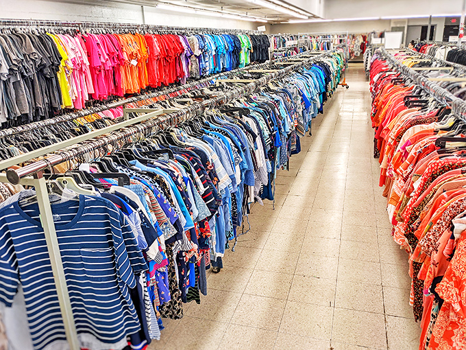 A rainbow of secondhand clothing organized by color creates an oddly satisfying visual feast that would make Marie Kondo proud.
