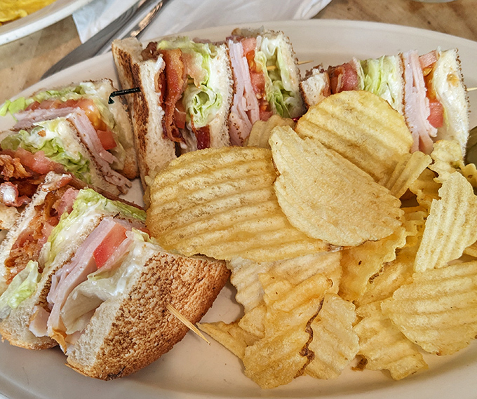 The club sandwich: architectural marvel of toast, meat, and veggies that requires both hands and possibly an engineering degree to eat.