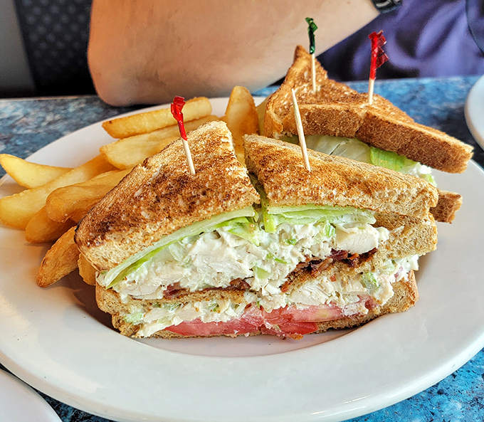 The club sandwich—architecture's greatest contribution to lunch—stacked higher than your weekend to-do list and twice as satisfying.