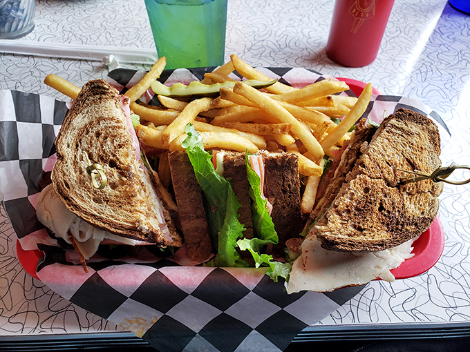 The club sandwich&mdash;architecture you can eat. Three perfectly toasted stories of satisfaction with golden fries as the perfect next-door neighbors.