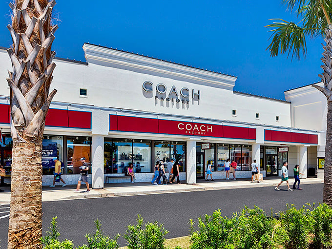 The Coach mothership has landed in Miramar Beach. Its red and white facade promises leather goods that will outlast most of your relationships.