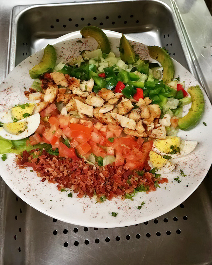 A colorful Cobb salad arranged with the precision of an artist's palette. Proof that healthy eating doesn't have to be a punishment.