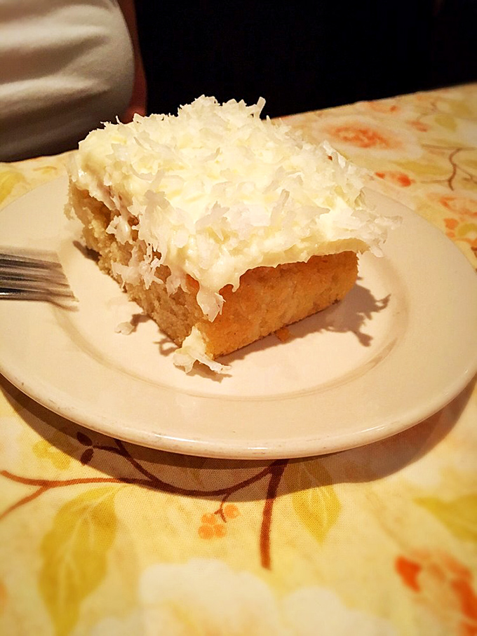 The coconut cake doesn't need fancy plating or edible flowers&mdash;it's the dessert equivalent of a perfect punchline, simple and utterly satisfying. 