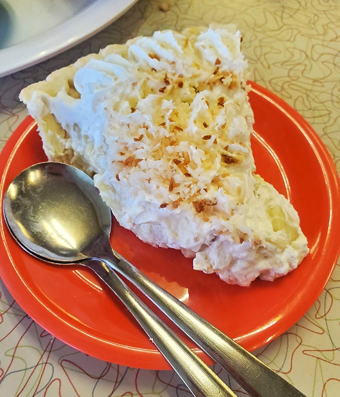 Coconut cream pie so tall and proud it deserves its own zip code. That toasted coconut sprinkle isn't garnish&mdash;it's the crown jewels.