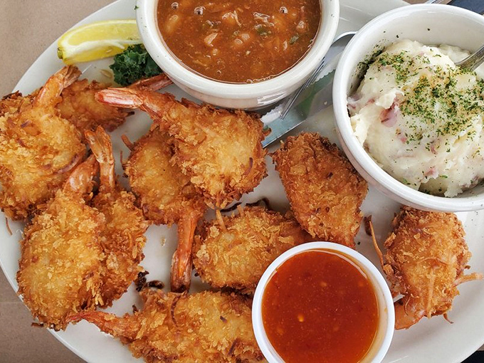 Coconut shrimp so perfectly golden they deserve their own trophy, accompanied by sides that aren't afterthoughts but worthy co-stars in this seafood drama.
