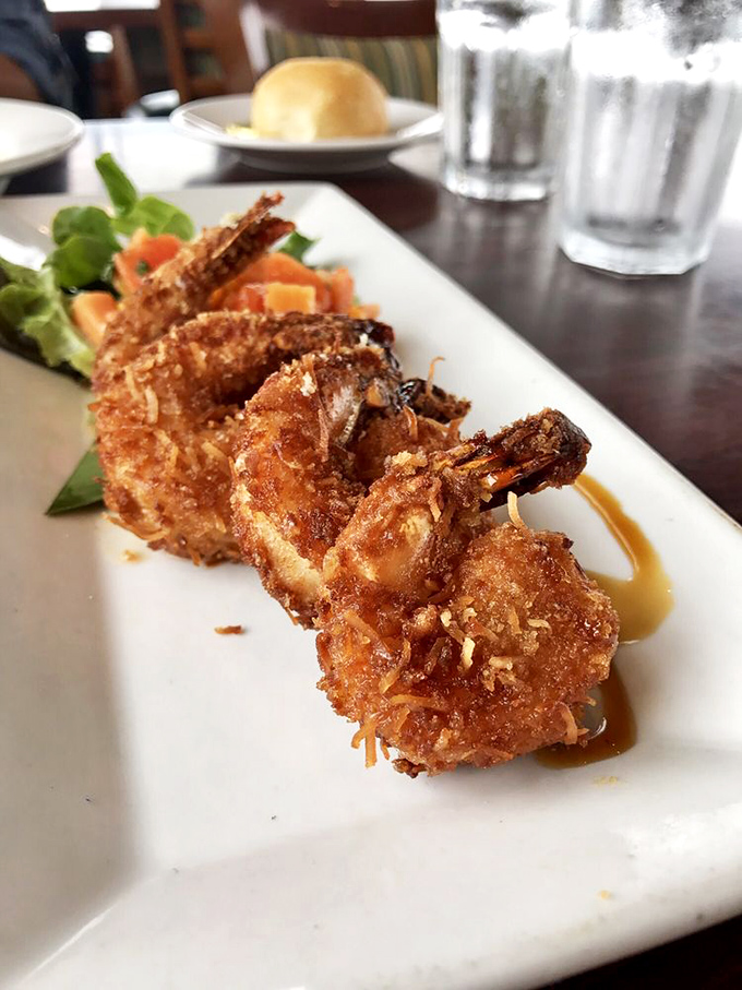 Coconut prawns with a golden crunch that would make King Midas jealous. That sweet-savory combination is the culinary equivalent of finding beach treasure.