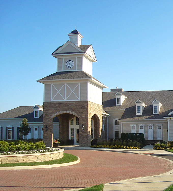 The clock tower community center stands as both architectural centerpiece and social hub&mdash;where retirement dreams come with brick-paved driveways.