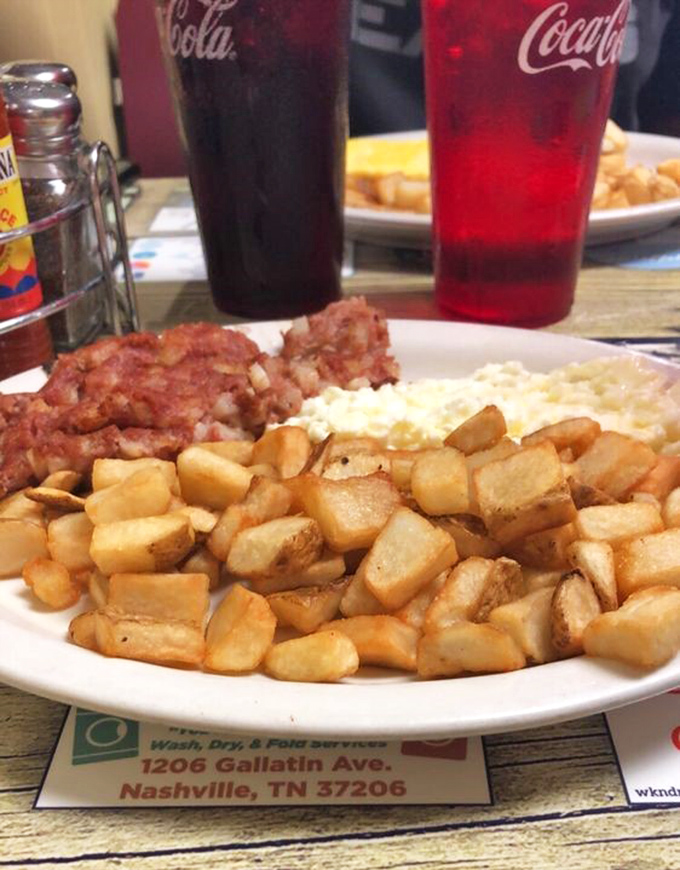 The holy trinity of breakfast: crispy home fries, fluffy eggs, and savory corned beef hash. Add Coca-Cola and you've got religion.