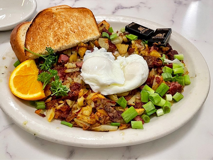 Corned beef hash that doesn't come from a can, topped with poached eggs whose yolks are about to create the world's most delicious lava flow.
