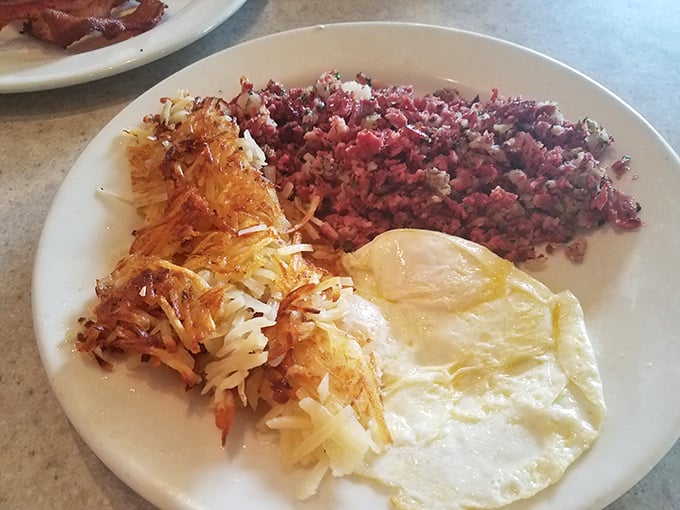 Corned beef hash with eggs and hash browns &ndash; the breakfast trinity that's converted more people than Sunday sermons. That crispy edge is pure salvation.