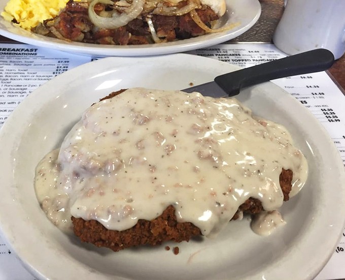 Country fried steak swimming in peppery gravy &ndash; a dish that doesn't just stick to your ribs, it sends them a thank-you note afterward.
