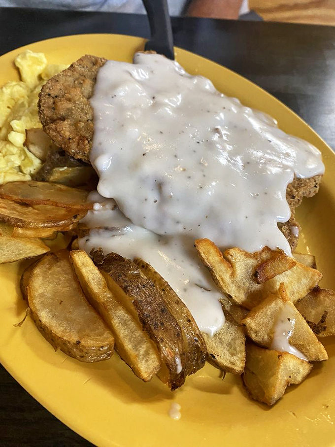 Country fried steak smothered in gravy is the breakfast equivalent of a warm hug from someone who genuinely likes you.