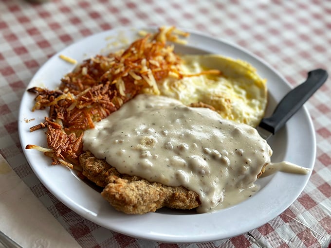 Country fried steak smothered in that signature gravy with crispy hash browns&mdash;a plate that says "your diet starts tomorrow" in the most delicious way possible.. country fried steak