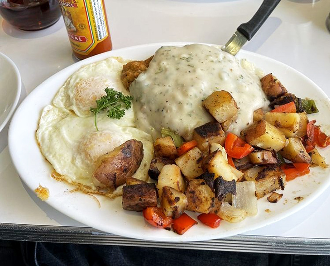 Country fried steak smothered in gravy alongside crispy potatoes and eggs—the breakfast equivalent of a warm hug from your favorite aunt.