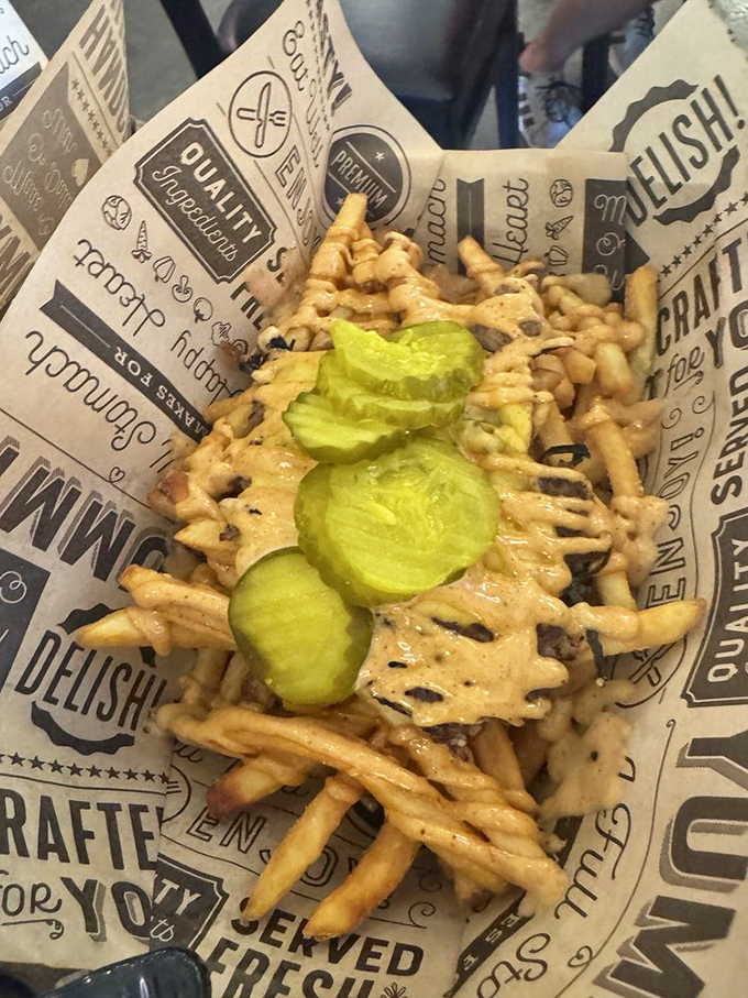 These loaded fries aren't just a side dish&mdash;they're a main event, with pickles standing at attention like tiny green sentinels of tang.