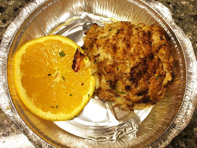 Maryland's seafood legacy transformed into a golden-brown masterpiece. This crab cake and orange slice duo is the state's culinary handshake.