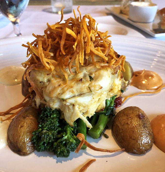 Not your grandmother's crab cake&mdash;this towering creation with crispy crown sits atop vibrant vegetables like Neptune's scepter.