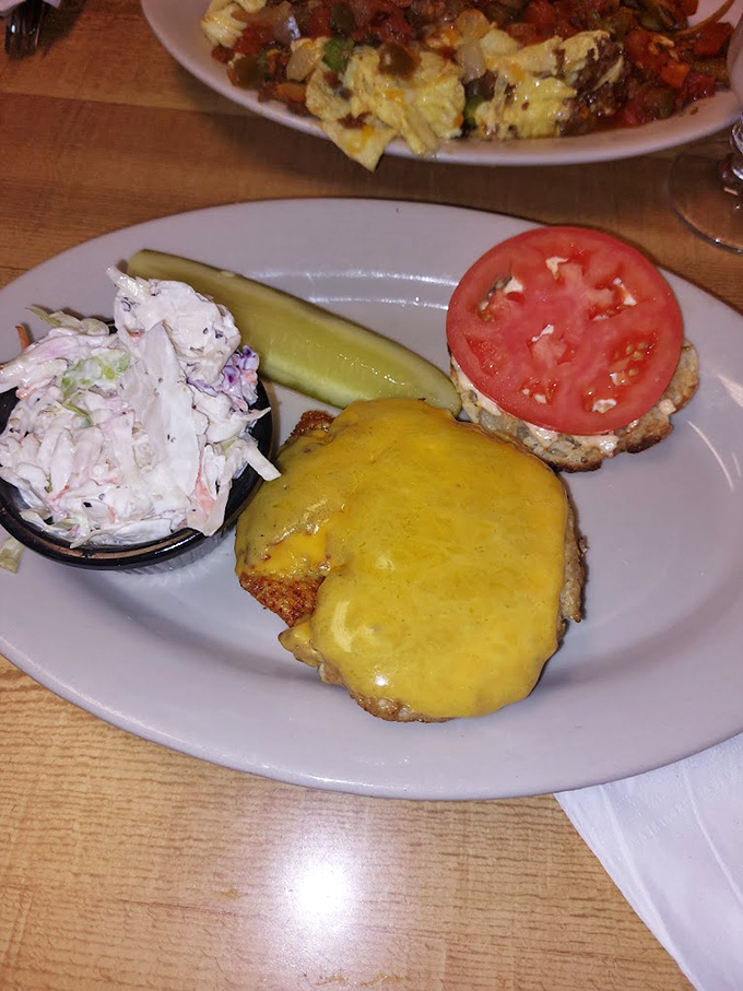 A sandwich that demands both hands and your full attention&mdash;melty cheese, fresh tomato, and coleslaw that doesn't apologize for being exactly what it is.