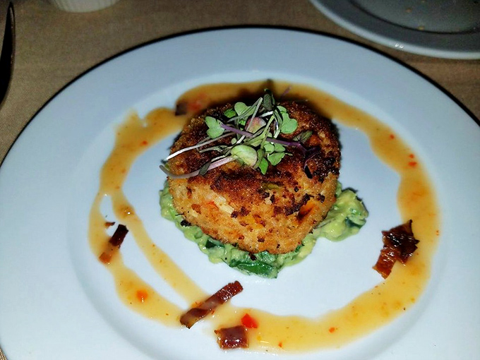 The humble crab cake, elevated to art form. Golden-crisp exterior giving way to sweet crab meat&mdash;this isn't just dinner, it's maritime poetry on a plate.