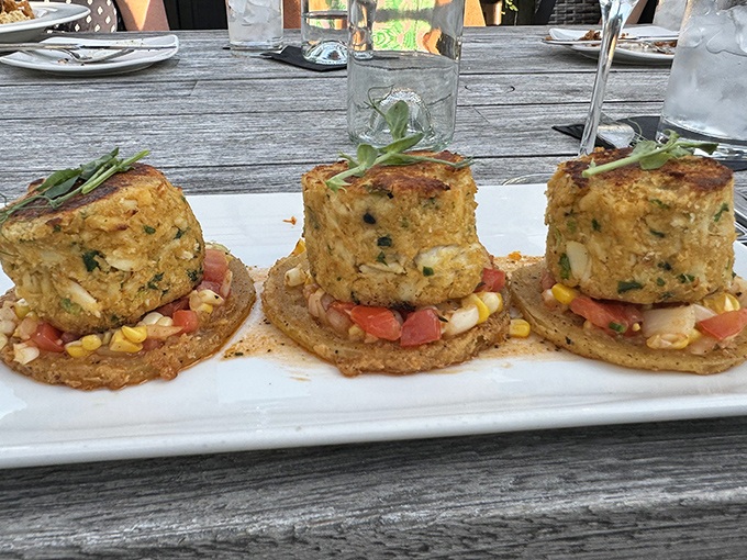 Crab cakes that don't hide behind fillers—they proudly showcase their seafood credentials. Perched atop colorful corn salsa, they're little islands of flavor worth exploring.
