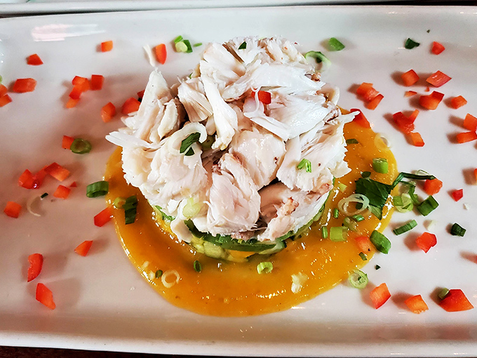 Delicate crab cakes perched atop a vibrant sauce – proof that seafood inland can still make coastal towns jealous.