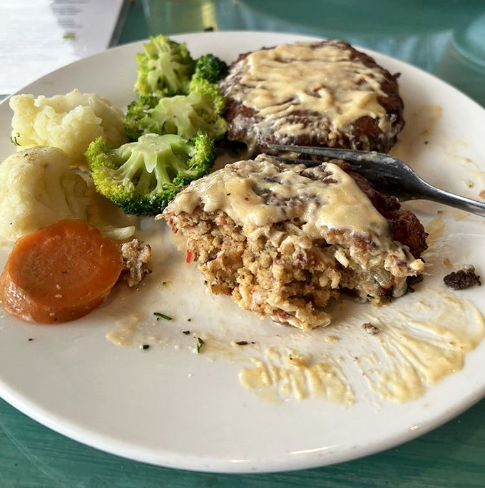 Not your average meatloaf! These seafood-packed patties swimming in creamy sauce prove that comfort food speaks fluent Floridian.
