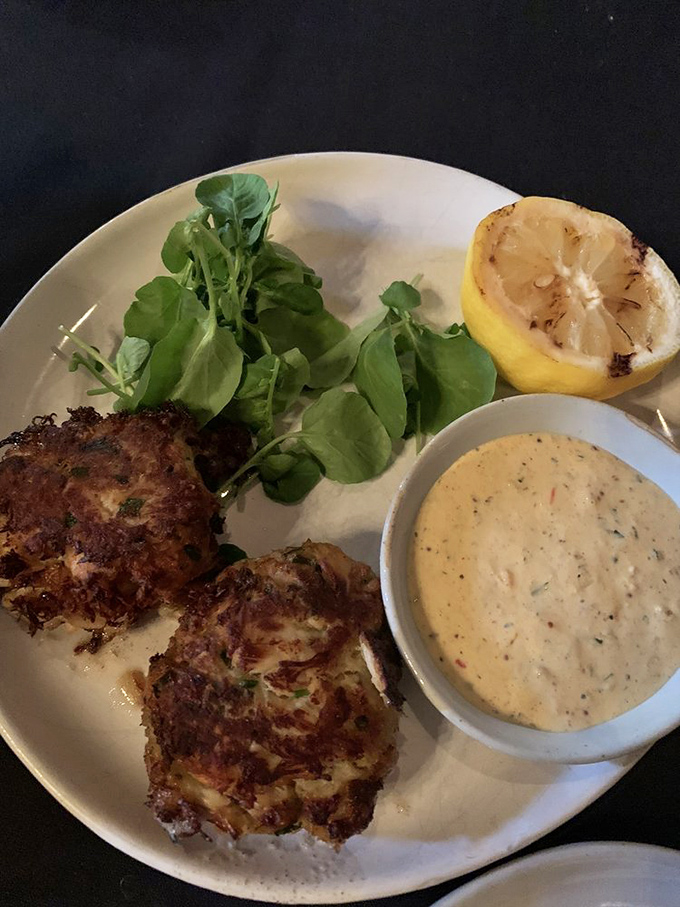 These crab cakes aren't just appetizers&mdash;they're little islands of seafood bliss, served with a sauce that deserves its own fan club.