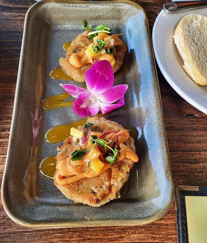 These crab cakes aren't just golden-brown perfection&mdash;they're edible postcards from the sea, complete with a tropical flower greeting.