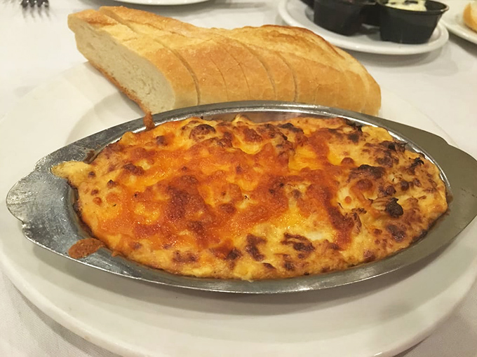 The bubbling crab dip arrives like molten treasure, its cheesy crown begging to be scooped up with that crusty bread—resistance is deliciously futile.