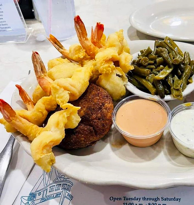 A plate that speaks the universal language of "yum." Plump shrimp, a golden crab cake, and fresh sides&mdash;Florida's coastal bounty on display.