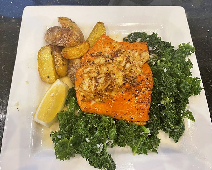 Salmon that doesn't just sit on a bed of kale—it commands it, like Neptune ruling over a sea of crispy potatoes and greens.