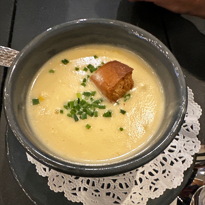 The legendary crab bisque in all its glory. Velvety, rich, and worth every mile of the drive. This isn't soup &ndash; it's liquid gold.