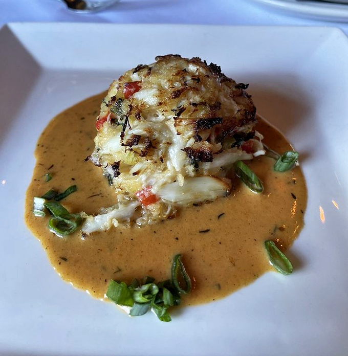 Not all crab cakes are created equal. This golden-crusted beauty swimming in sauce makes ordinary versions seem like distant, less-talented relatives.