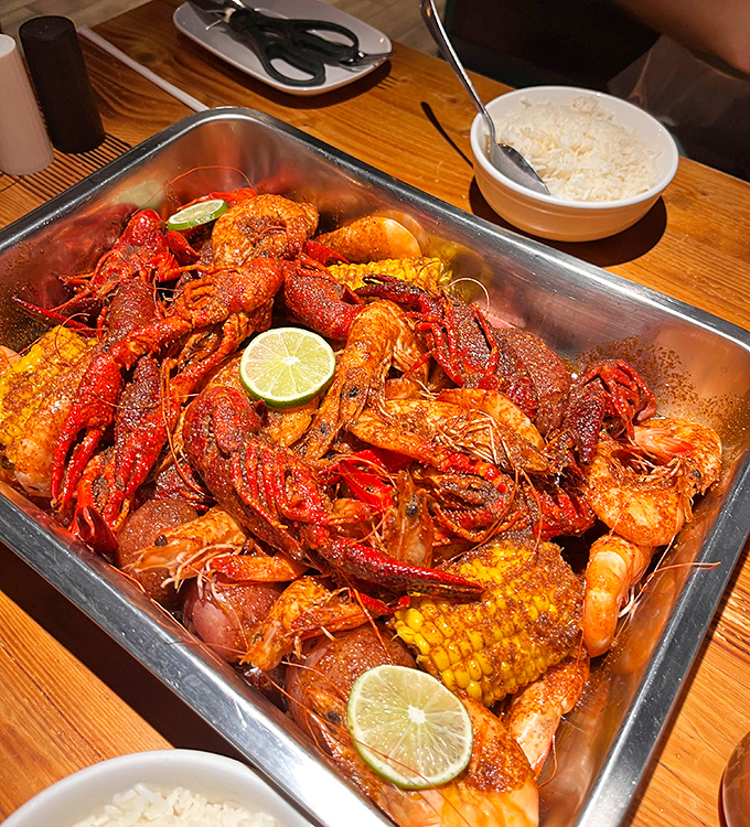 A glorious crimson pile of crawfish, corn, and potatoes that would make New Orleans proud. Bibs aren't optional—they're essential survival gear.