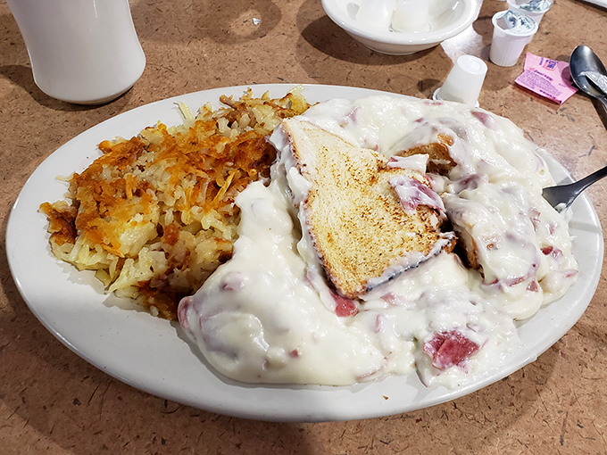 Creamed chipped beef on toast—what grandparents lovingly called SOS—smothered in velvety gravy alongside golden home fries that crackle with each bite.