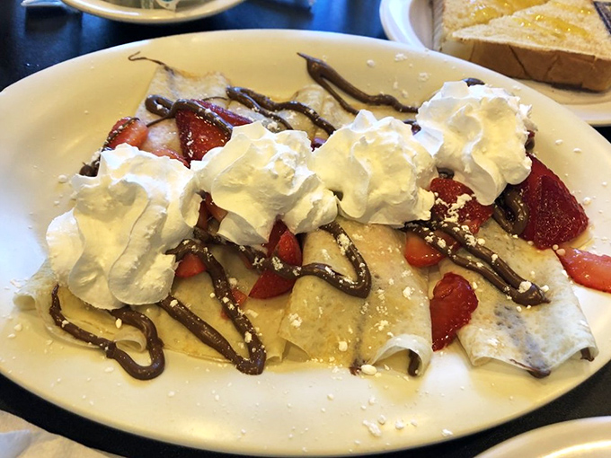 Dessert for breakfast? These crepes, draped in chocolate and crowned with whipped cream, make a compelling argument for starting your day with joy.