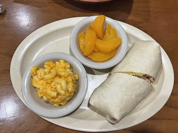 Mac and cheese that glows like Florida sunshine, peaches that taste like summer memories, and a wrap that holds it all together – lunch perfection.
