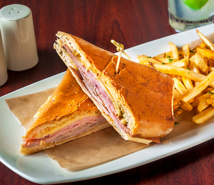 The Cuban sandwich—architecture you can eat—layers of ham, pork, and cheese pressed into a handheld masterpiece that puts desk lunches to shame.
