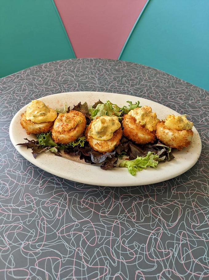 Deviled eggs get elevated treatment with herbed garnish, transforming humble appetizers into Instagram-worthy starters.