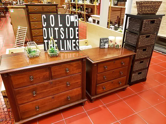 Solid wood dressers that have seen more history than your high school textbooks. That "Color Outside The Lines" sign is preaching to the thrift store choir.