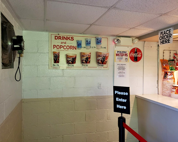 The concession stand menu—where movie theater classics are displayed with refreshing honesty. No artisanal pretensions here, just the snacks that defined your childhood.