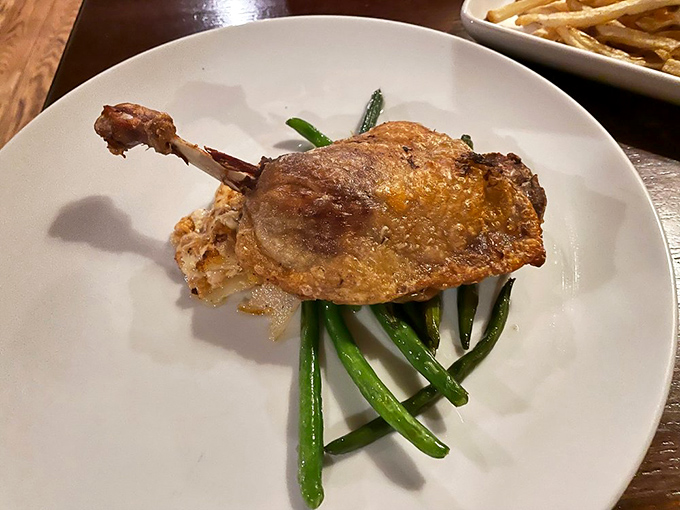 Duck that's achieved crispy-skin nirvana, perched atop vibrant green beans. The kind of dish that makes you close your eyes on the first bite.