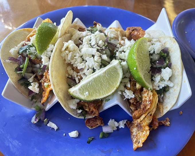 These aren't your average tacos – they're breakfast revolutionaries wrapped in soft tortillas, crowned with crumbled cheese and lime wedges.