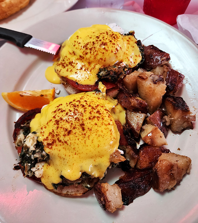 Hollandaise sauce cascading over perfectly poached eggs like a golden waterfall. Eggs Benedict: the breakfast that makes you feel fancy even in your weekend sweatpants.