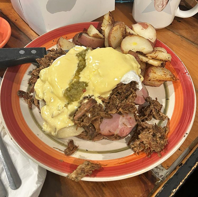 Behold the breakfast of champions: tender ham beneath a mountain of pulled pork, crowned with hollandaise that glistens like morning sunshine.