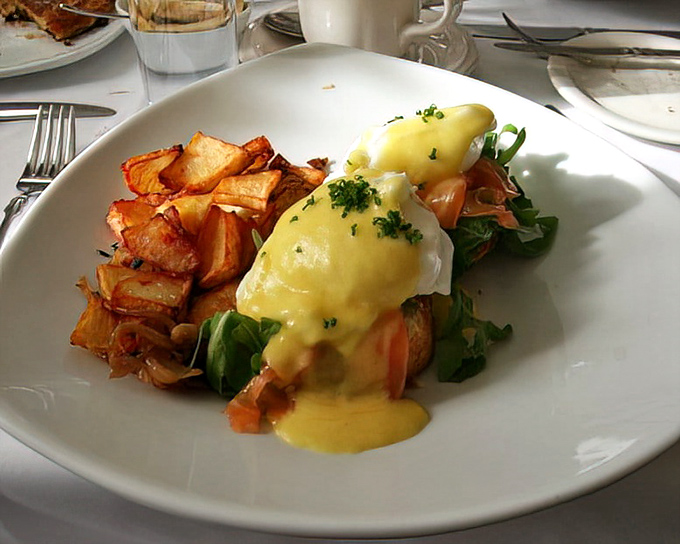 Eggs Benedict reimagined with such delicate perfection, the hollandaise cascades like liquid sunshine over local vegetables that practically sing with freshness.