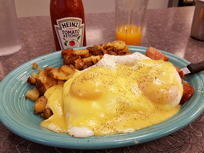 Hollandaise cascading over poached eggs like a golden waterfall&mdash;this Eggs Benedict isn't just breakfast, it's performance art.