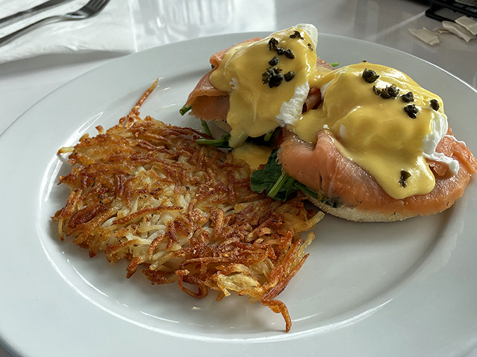 Eggs Benedict elevated to an art form&mdash;perfectly poached eggs nestled on salmon, draped in hollandaise that's sunshine on a plate, with crispy hash browns standing guard.