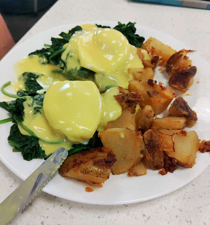 Eggs Benedict done right is breakfast's highest achievement&mdash;these poached perfections swimming in hollandaise prove someone in that kitchen genuinely cares about your morning.
